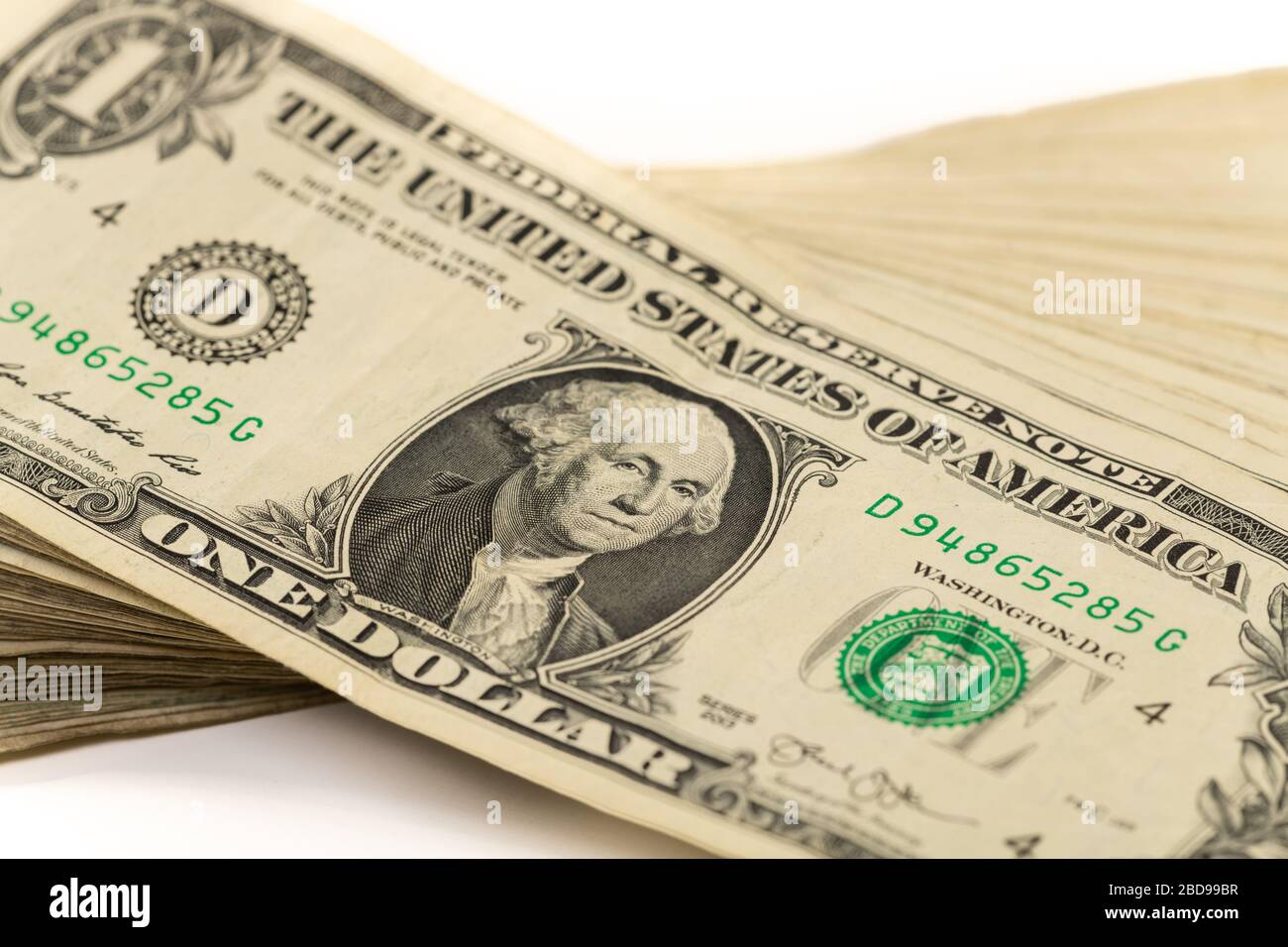 Stack of American dollar bills on top isolated on a white background ...