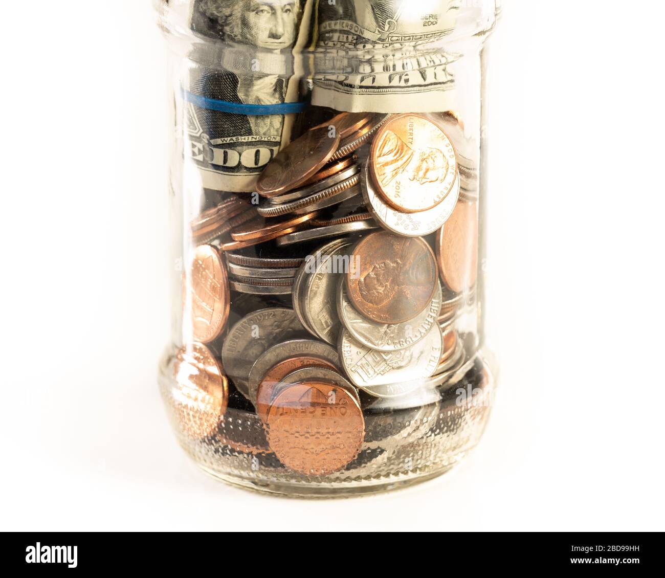 Glass jar of money isolated on a white background Stock Photo - Alamy