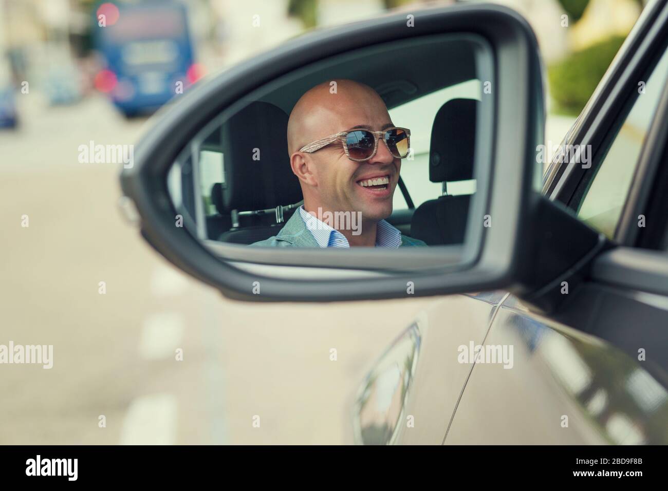 Closeup portrait of side view mirror car reflection of handsome ...