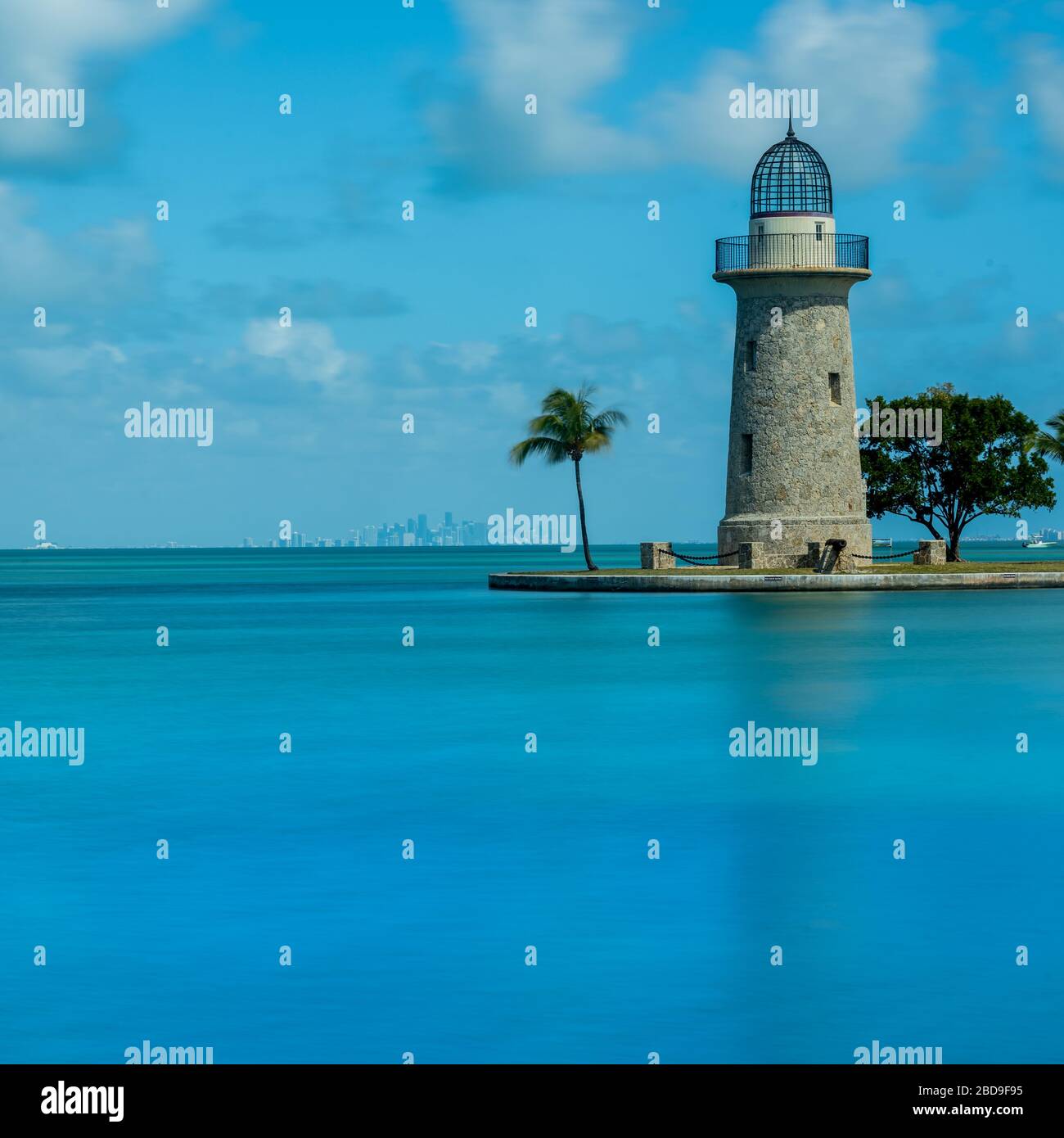 Boca Chita Lighthouse Reflecting in Blue Water with Miami skyline in ...