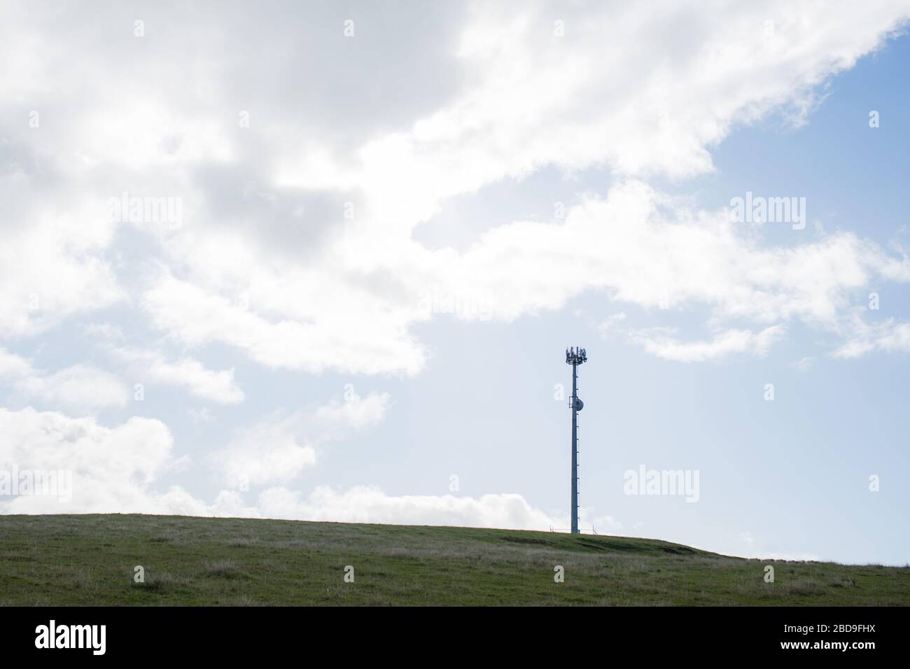 Landscape of mobile phone tower on farm land with sky and clouds in ...