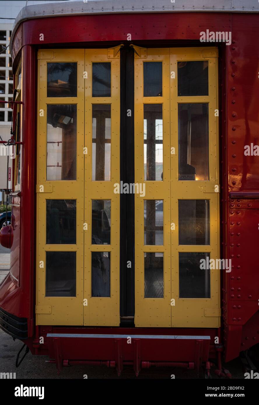 Yellow Trolley Doors on red painted unit Stock Photo - Alamy