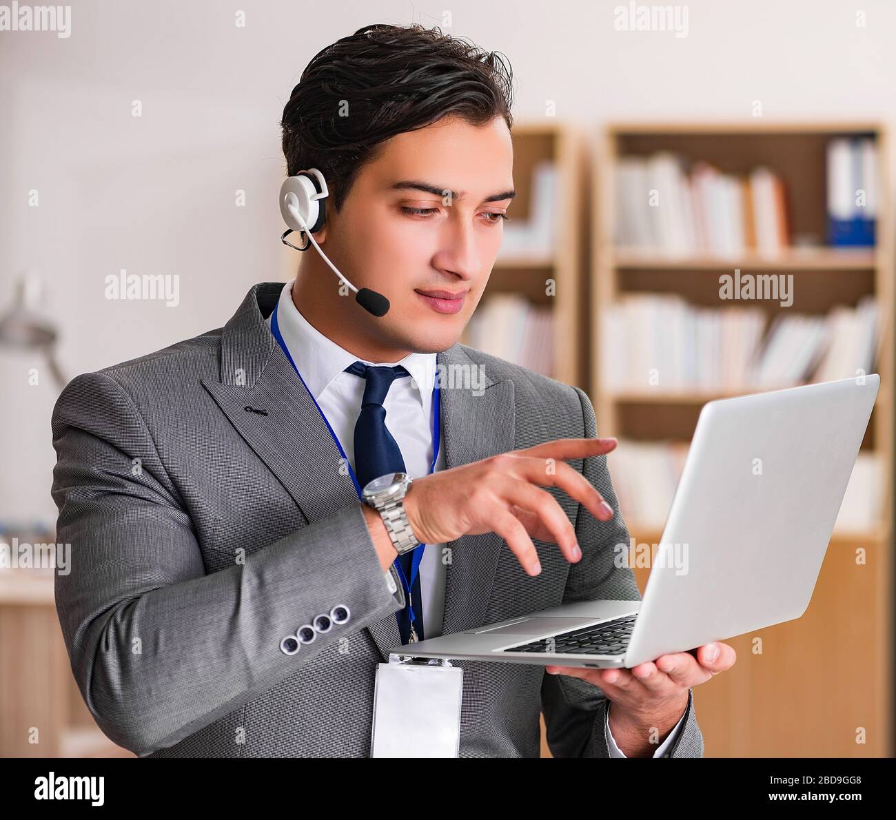 The handsome customer service clerk with headset Stock Photo - Alamy