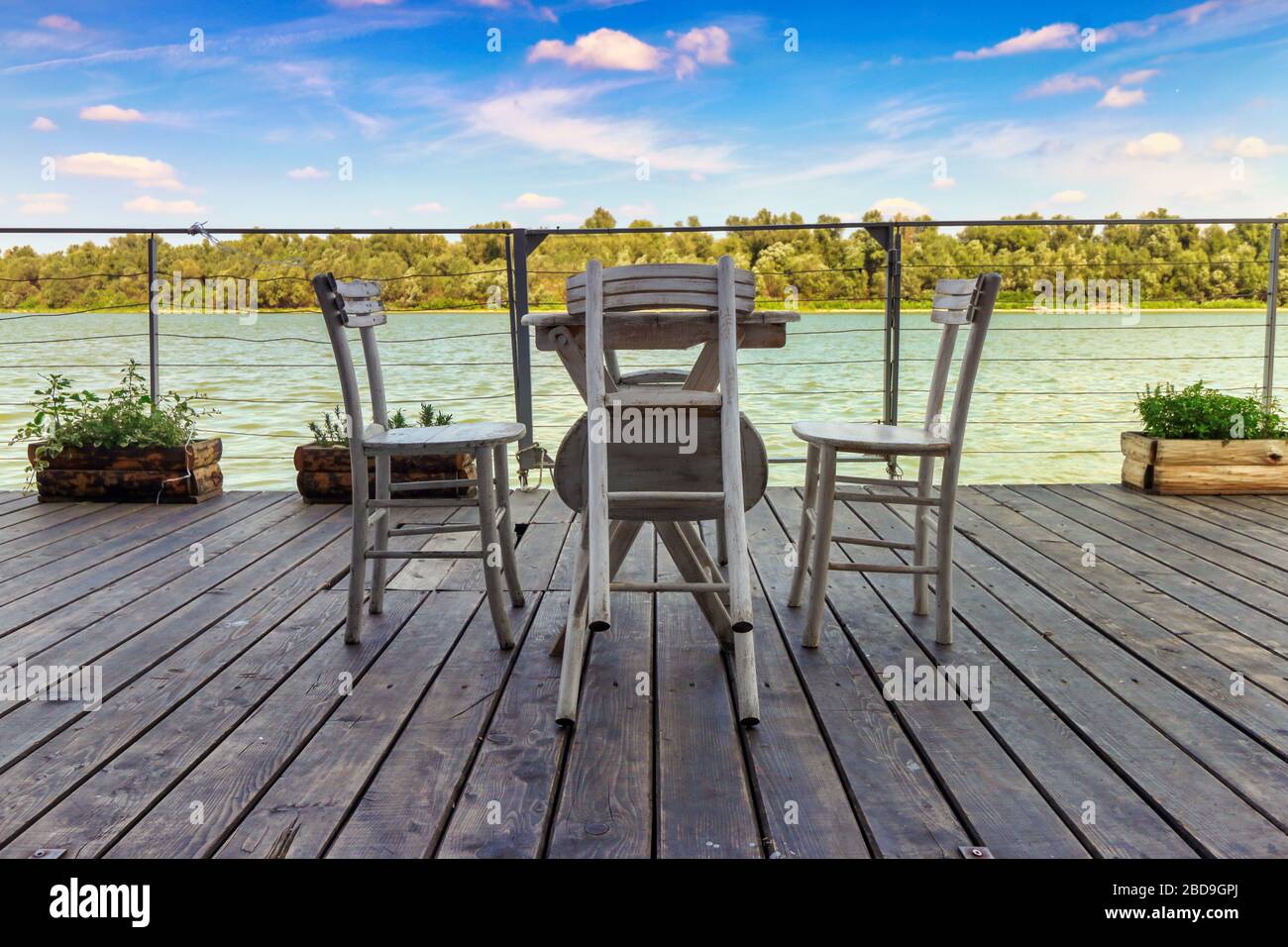 Dinner table and chairs at the back of floating waterfront at Sava ...