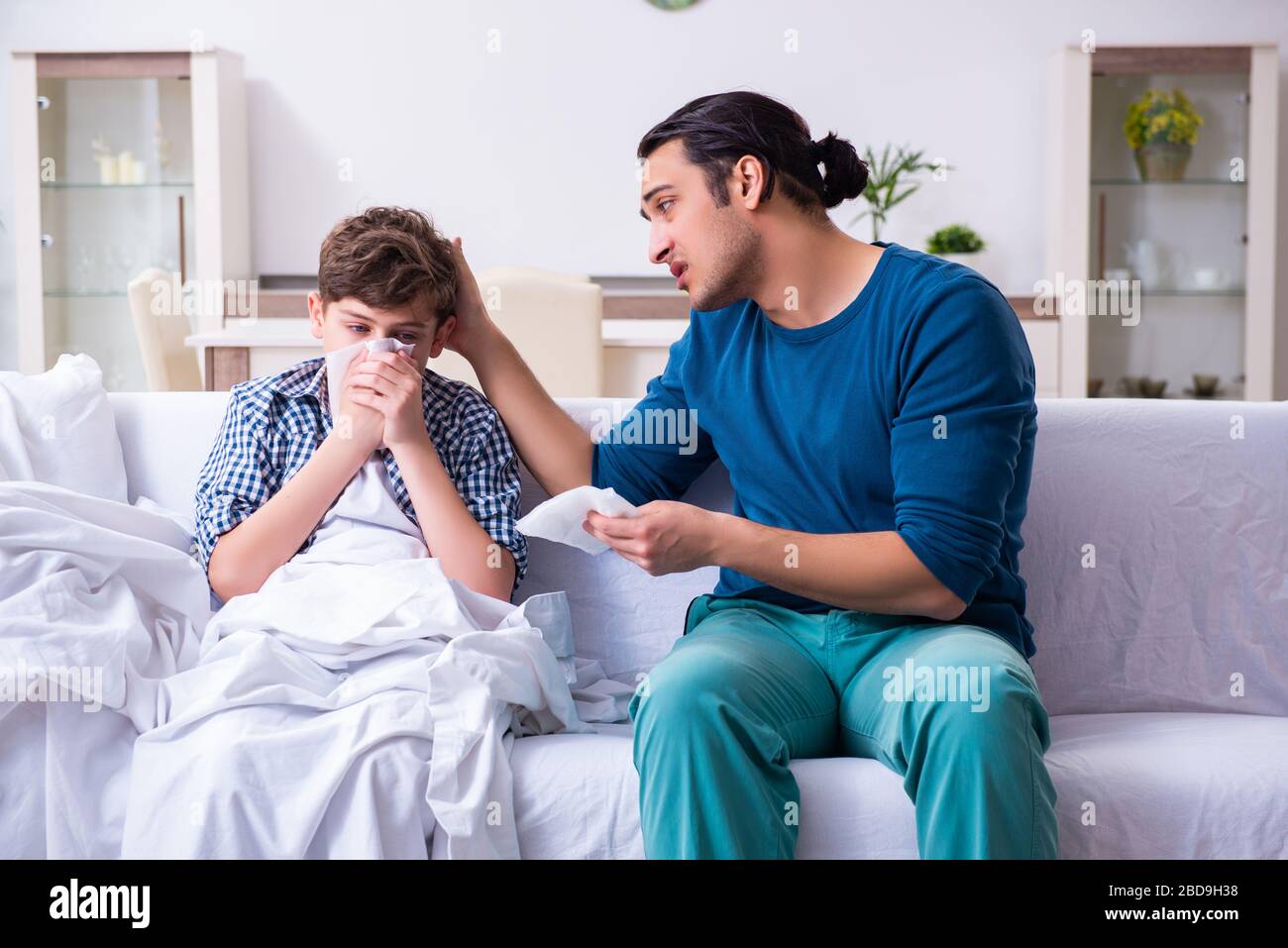 The young father caring for sick son Stock Photo - Alamy