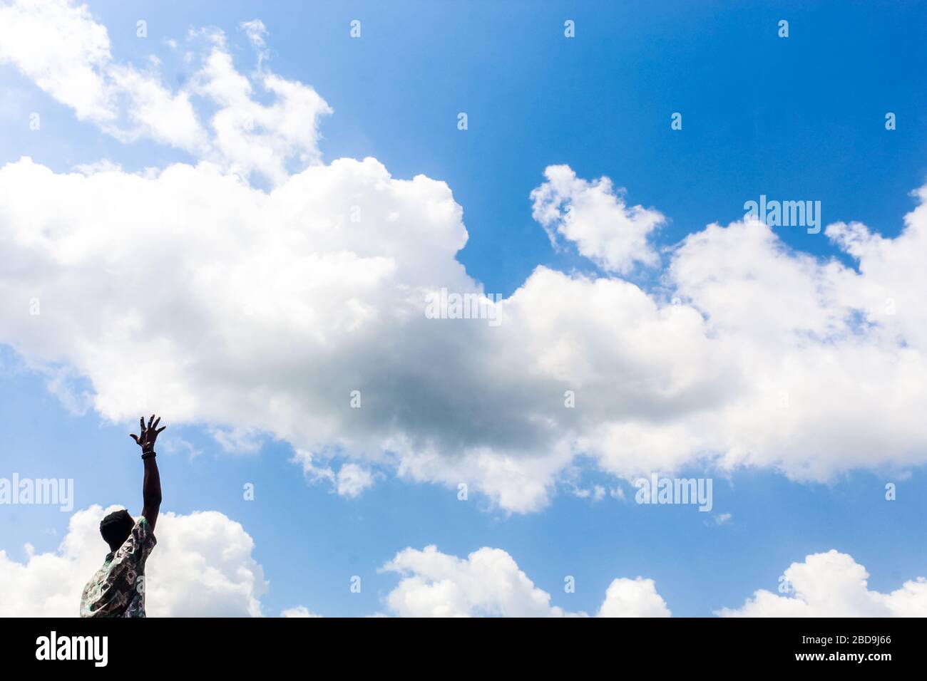 One Young Adult man Facing the Cloud and talking to God Stock Photo - Alamy