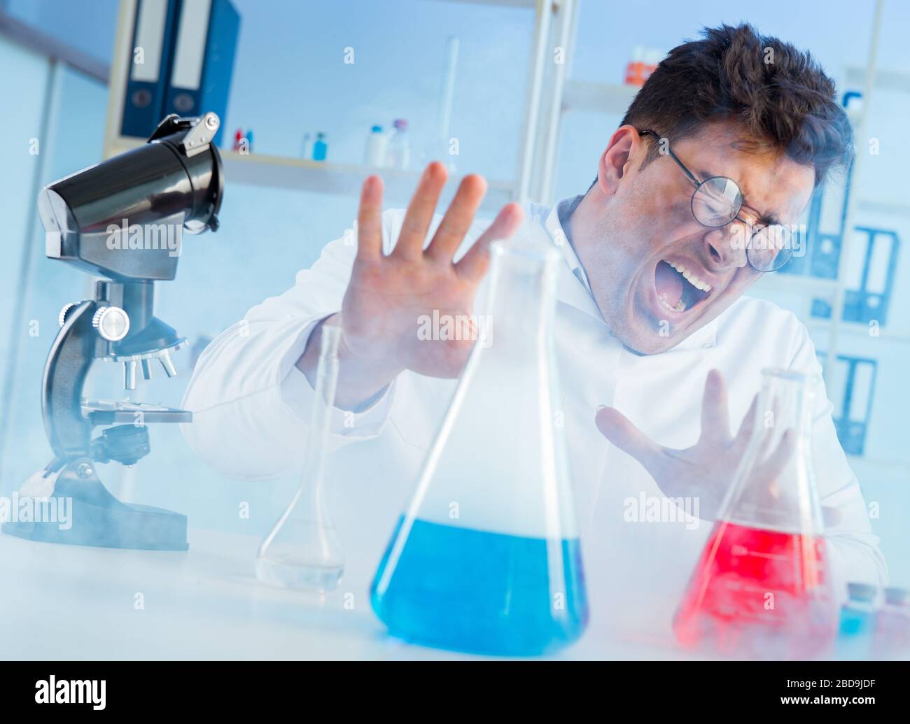 The funny mad chemist working in a laboratory Stock Photo - Alamy