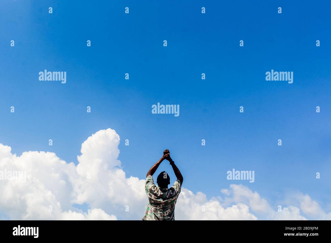 One Young Adult man Facing the Cloud and talking to God Stock Photo - Alamy