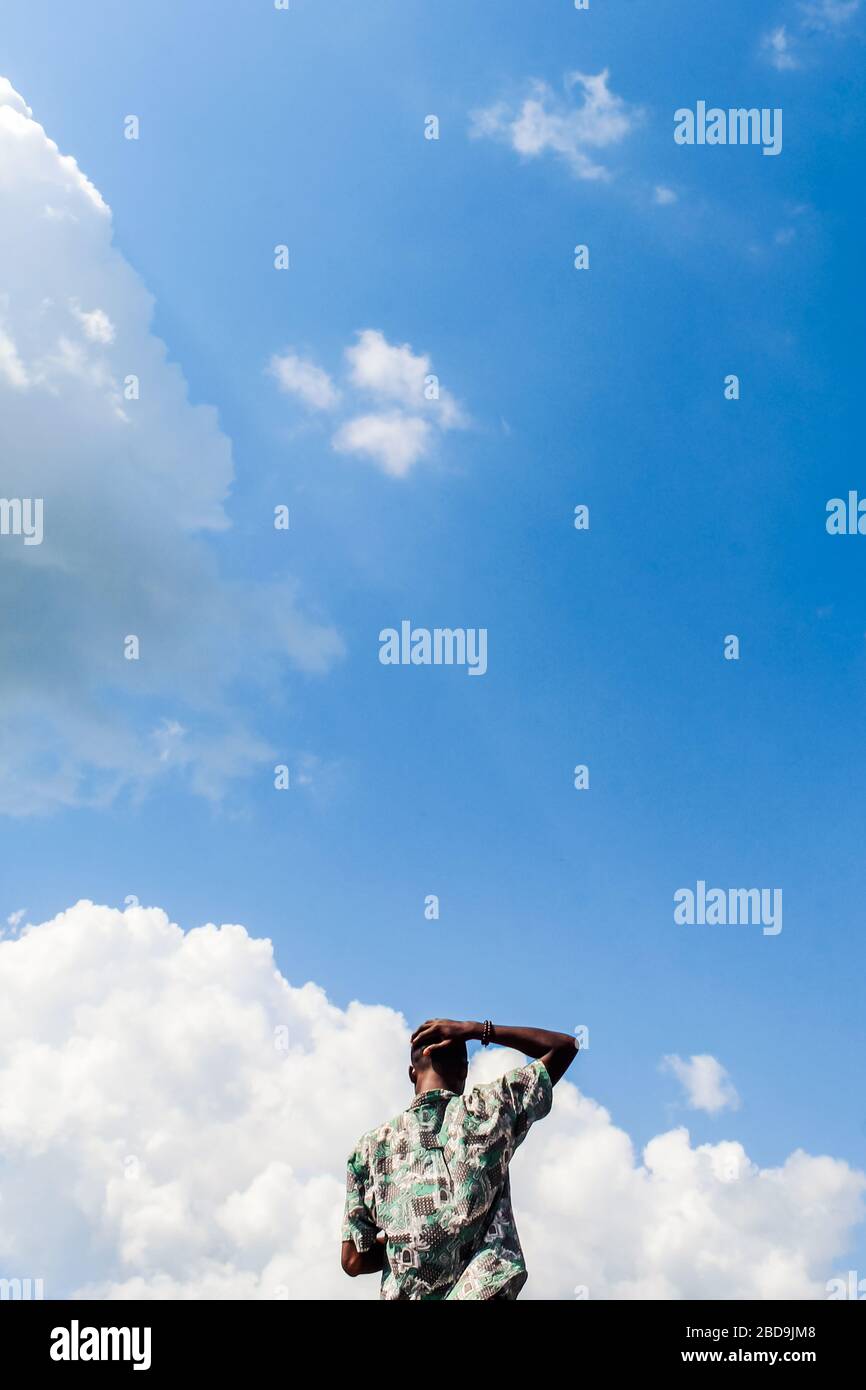One Young Adult man Facing the Cloud and talking to God Stock Photo - Alamy