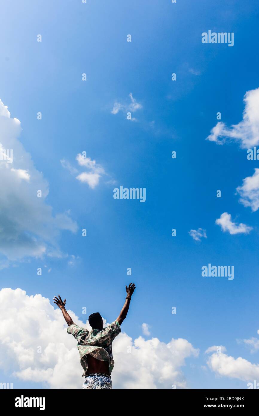One Young Adult man Facing the Cloud and talking to God Stock Photo - Alamy