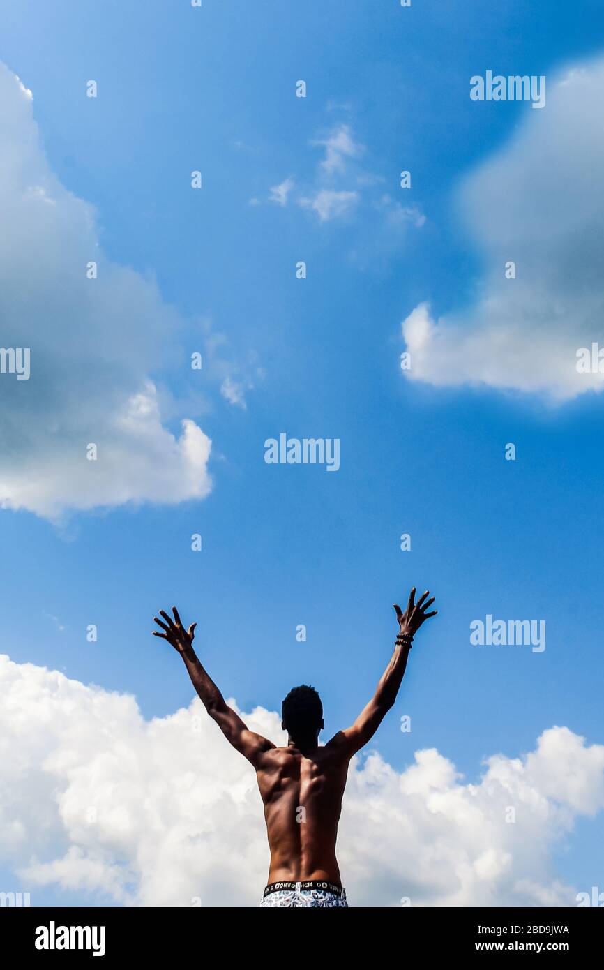 One Young Adult man Facing the Cloud and talking to God Stock Photo - Alamy