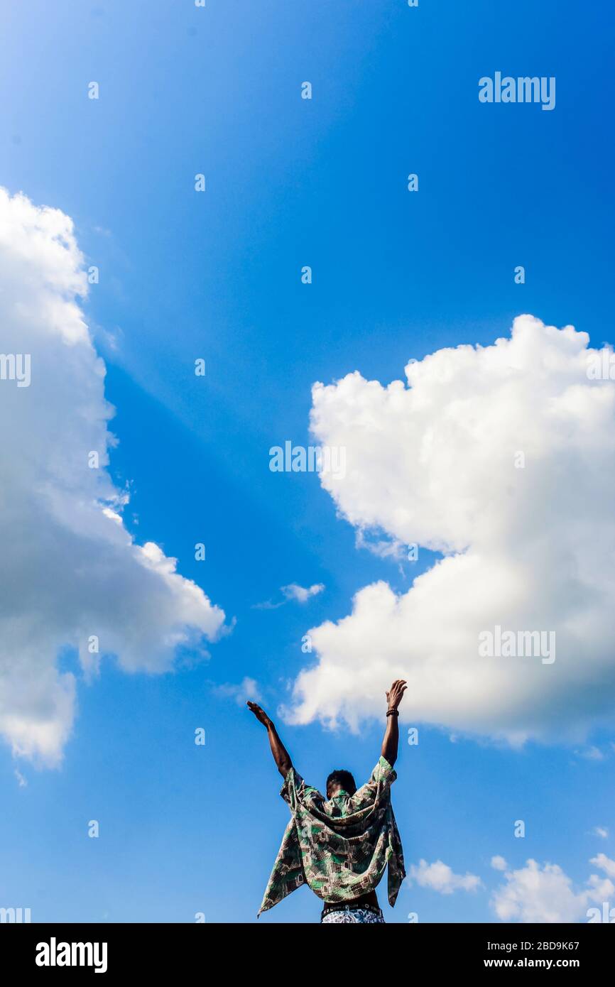 One Young Adult man Facing the Cloud and talking to God Stock Photo - Alamy