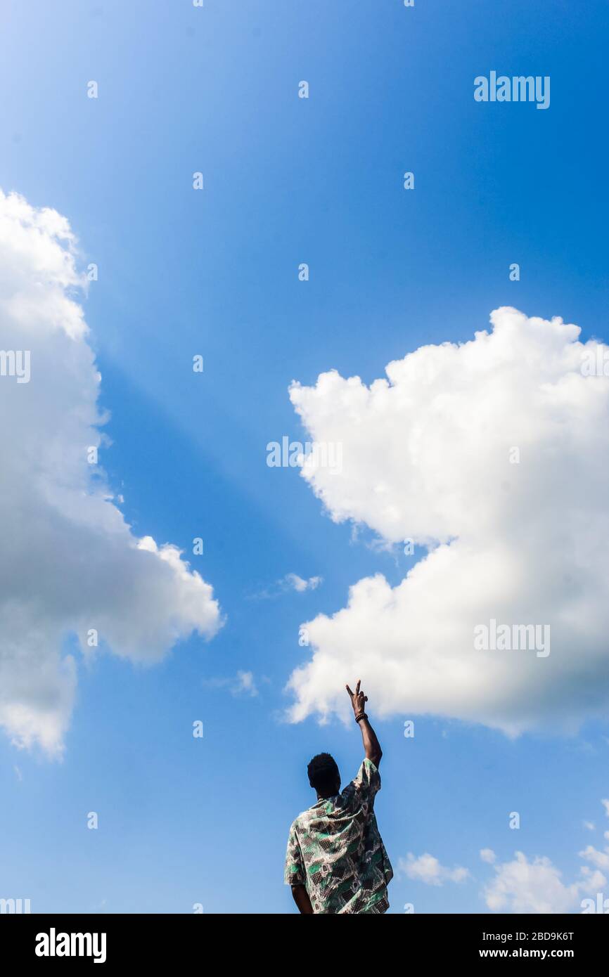 One Young Adult man Facing the Cloud and talking to God Stock Photo - Alamy