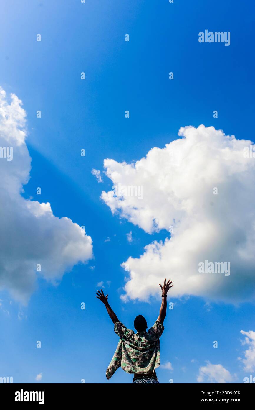 One Young Adult man Facing the Cloud and talking to God Stock Photo - Alamy