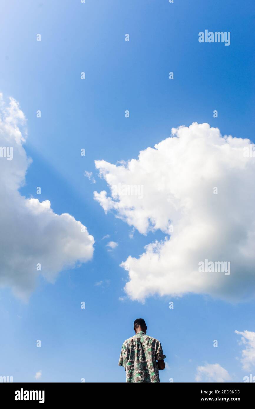 One Young Adult man Facing the Cloud and talking to God Stock Photo - Alamy