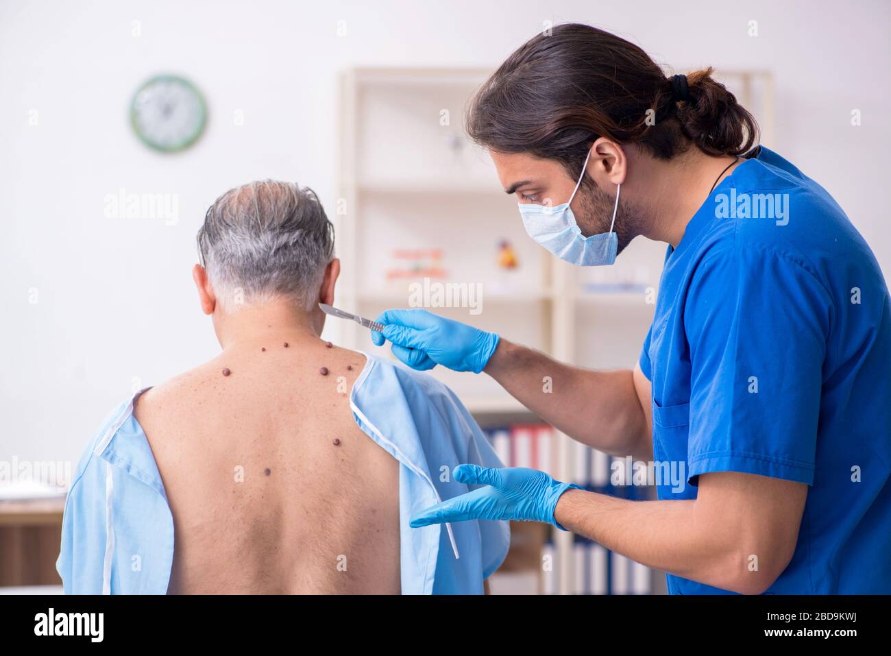 Old man visiting male doctor dermatologist Stock Photo - Alamy
