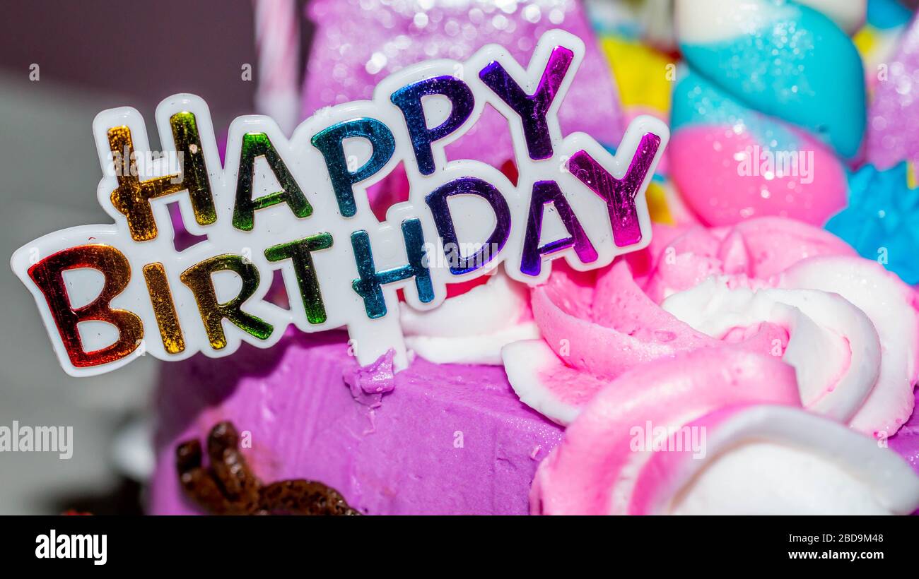 Happy birthday sign on colorful cake Stock Photo - Alamy