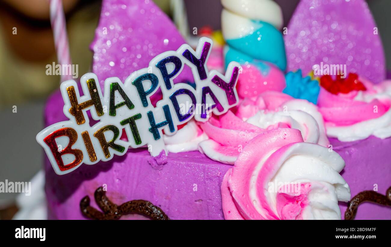 Happy birthday sign on colorful cake Stock Photo - Alamy