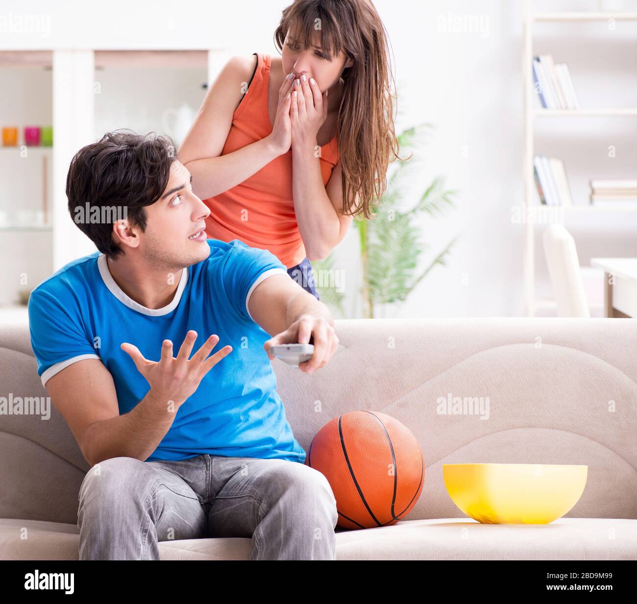 The man watching basketball with his wife Stock Photo - Alamy