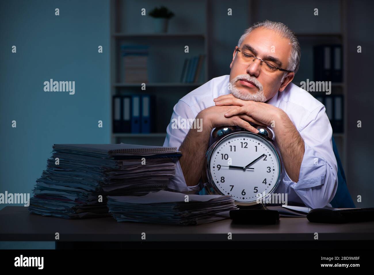 Old employee working late in the office Stock Photo - Alamy