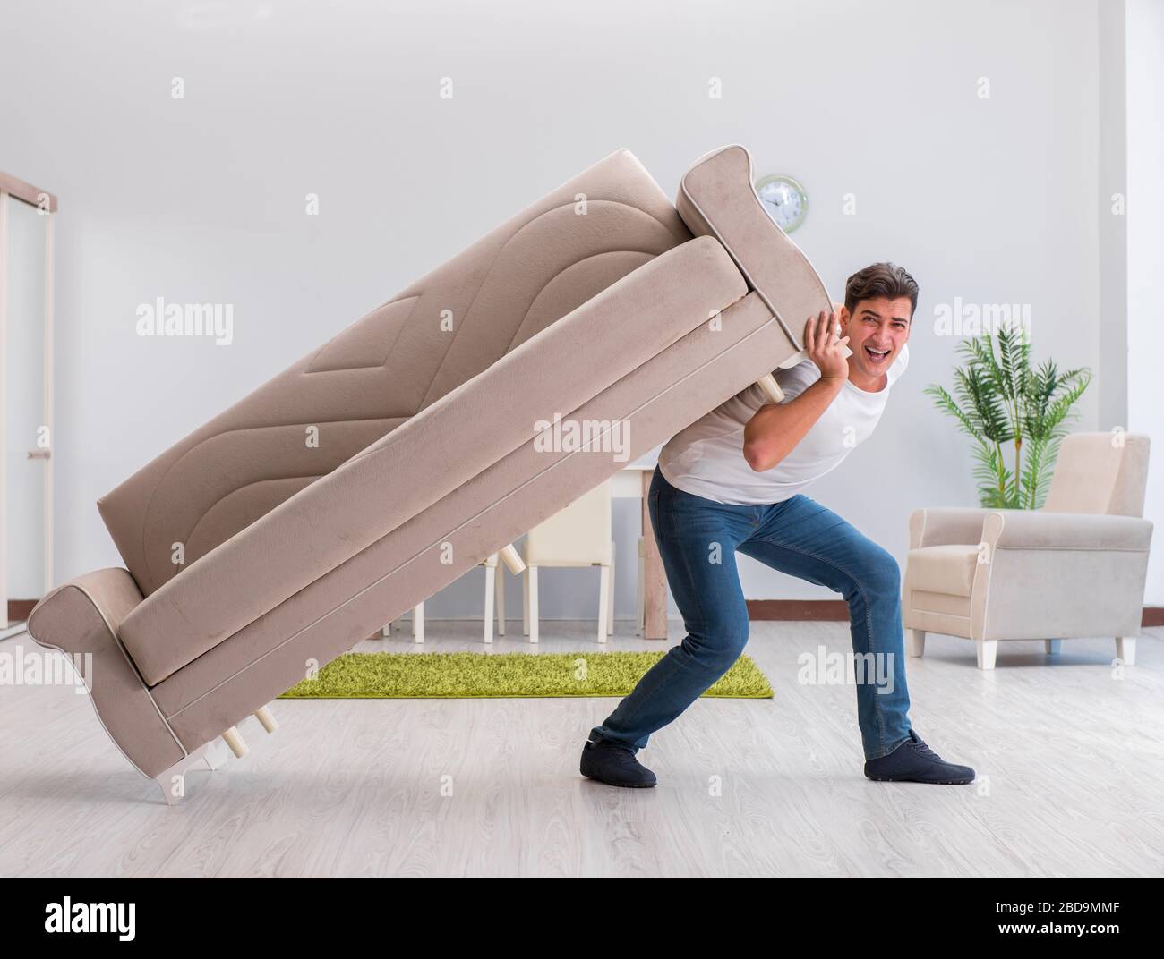 The man moving furniture at home Stock Photo - Alamy