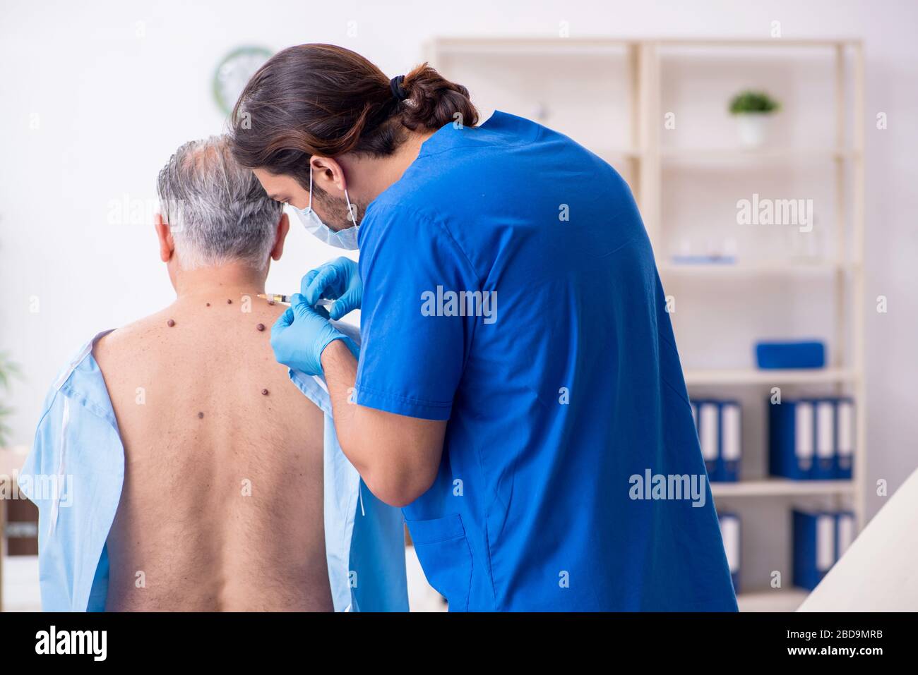 Old man visiting male doctor dermatologist Stock Photo - Alamy