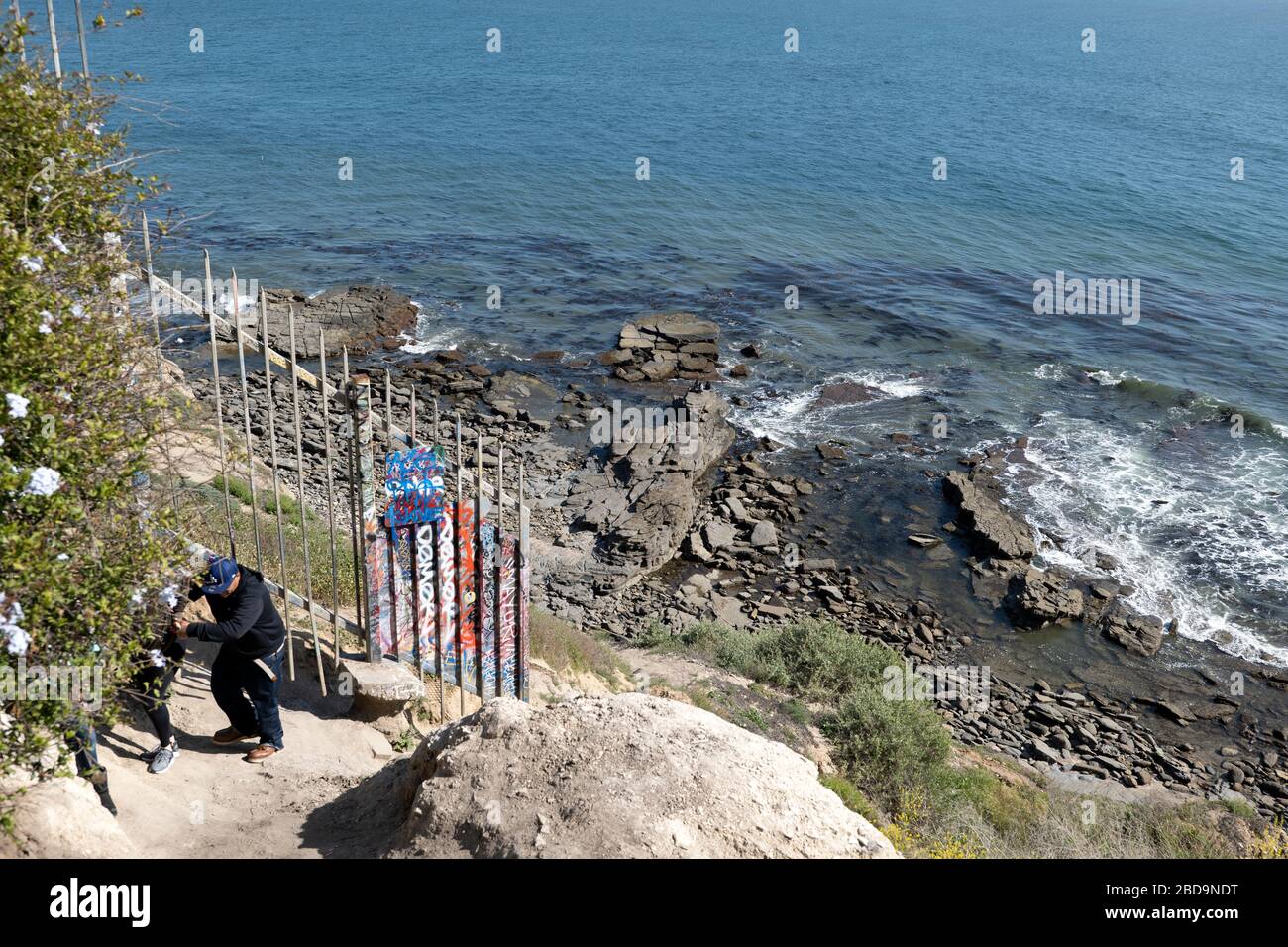 San Pedro, CA/USA - April 3, 2020: People climbing under the fence ...
