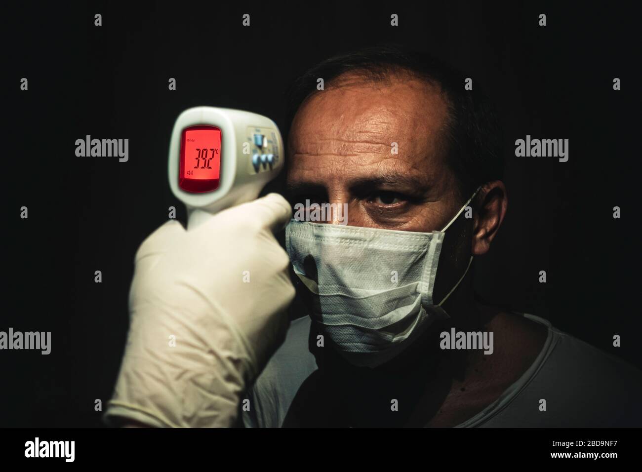 Closeup shot of a infrared thermometer measuring a senior man's ...