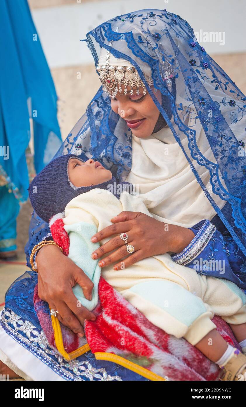 An Omani mother in traditional dress with her baby in Muscat, in the ...