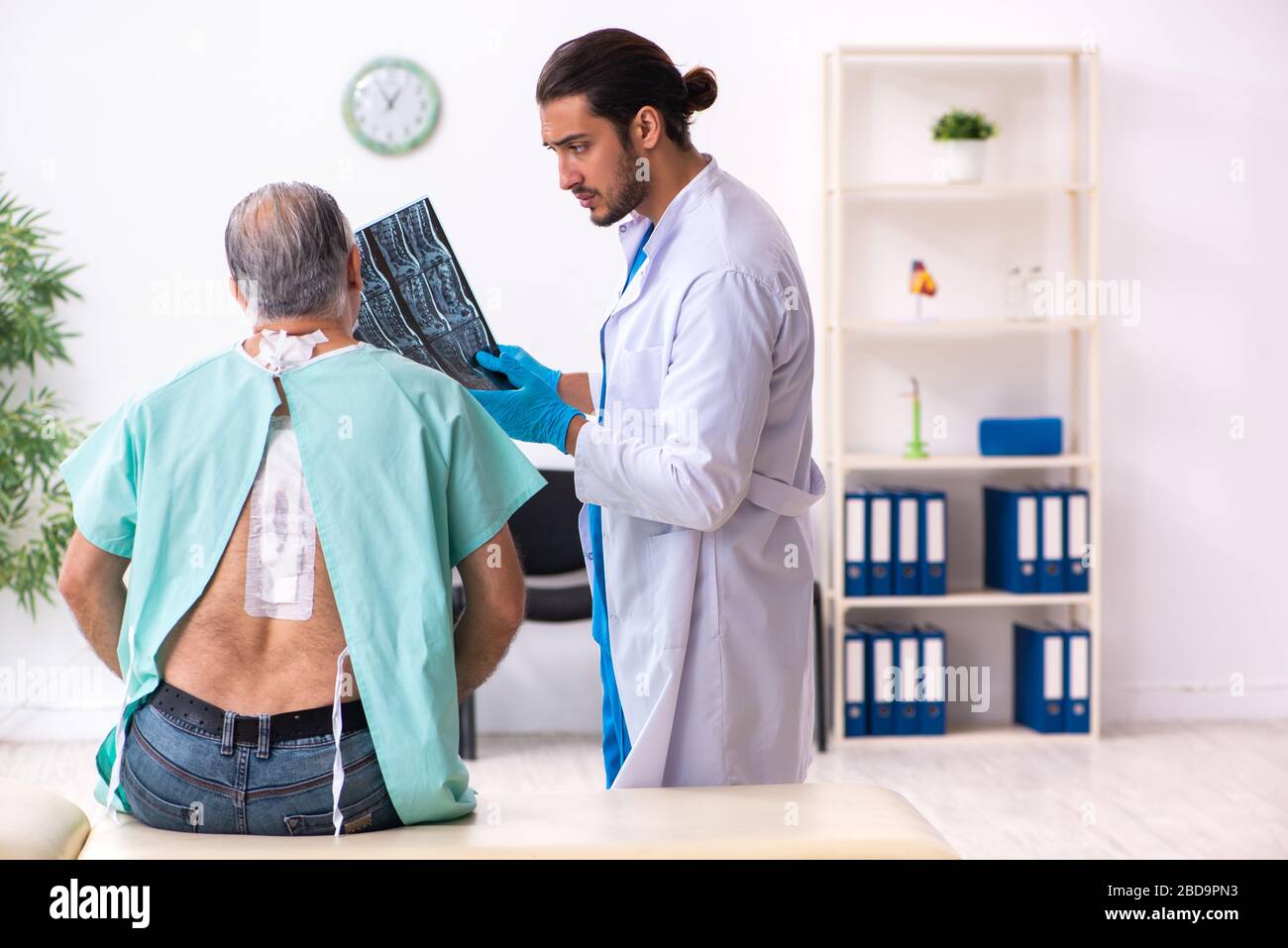 Old man visiting male doctor Stock Photo - Alamy