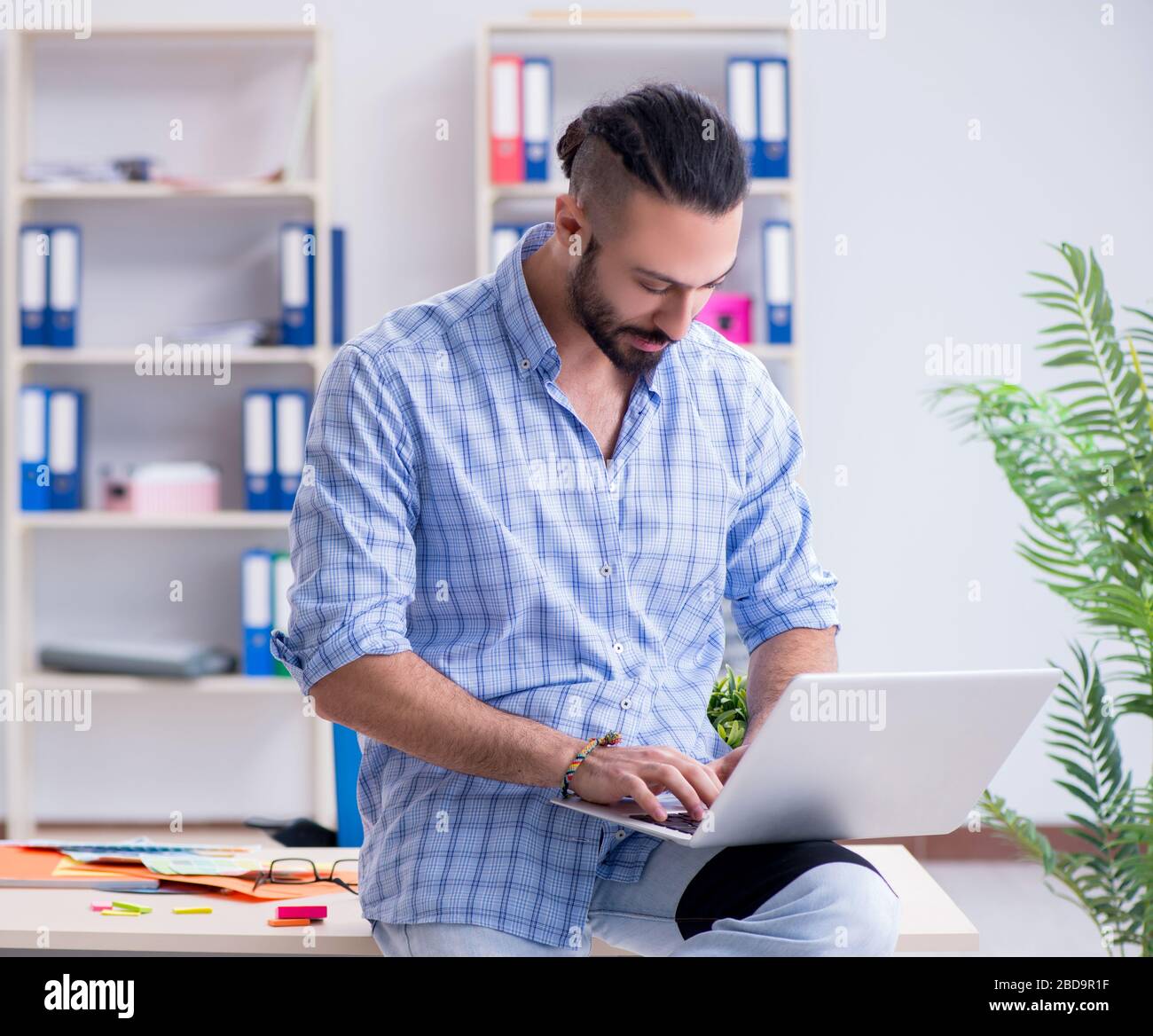 The young designer working in his studio on new project Stock Photo - Alamy