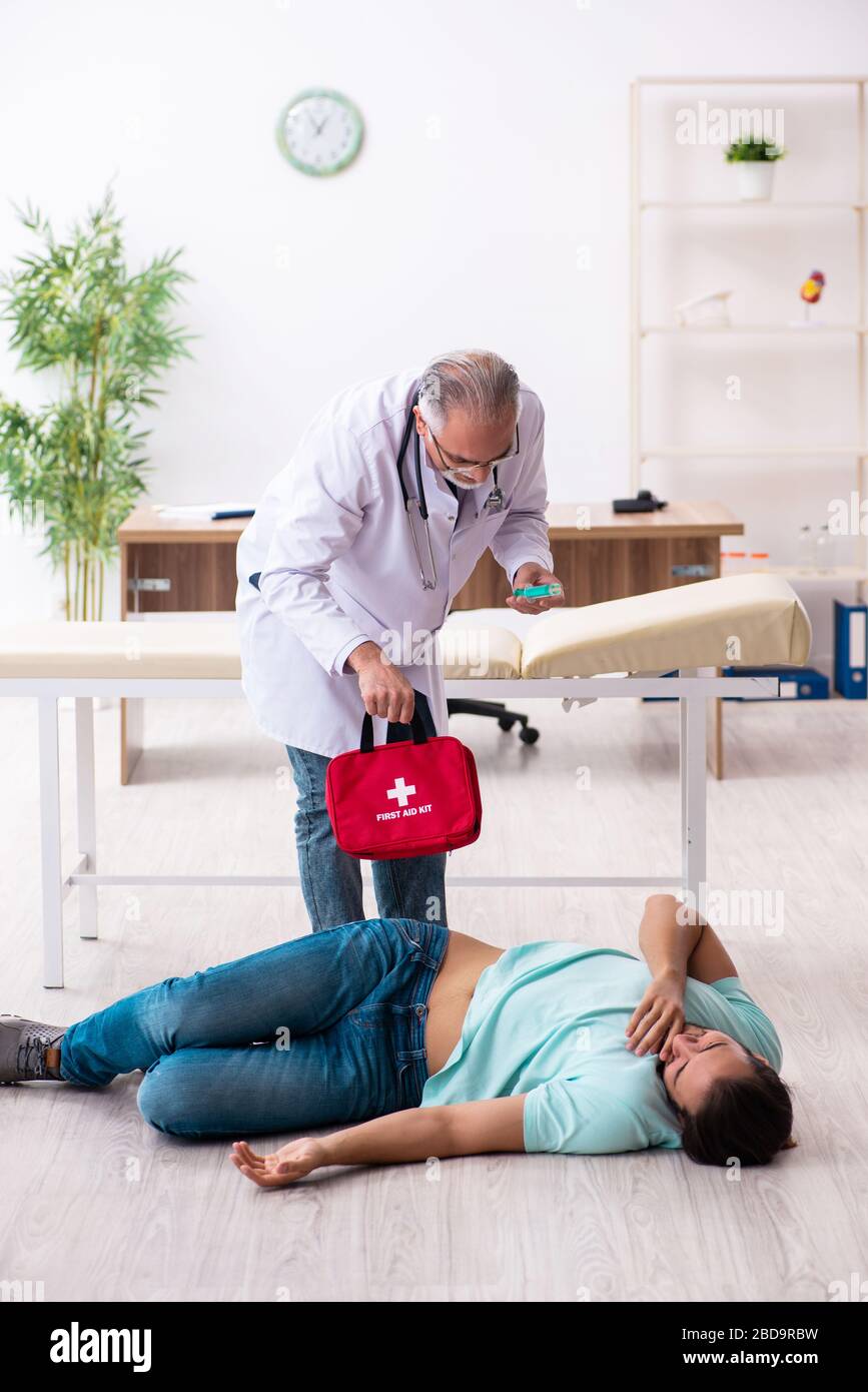 Paramedic examining unconscious patient hi-res stock photography and ...