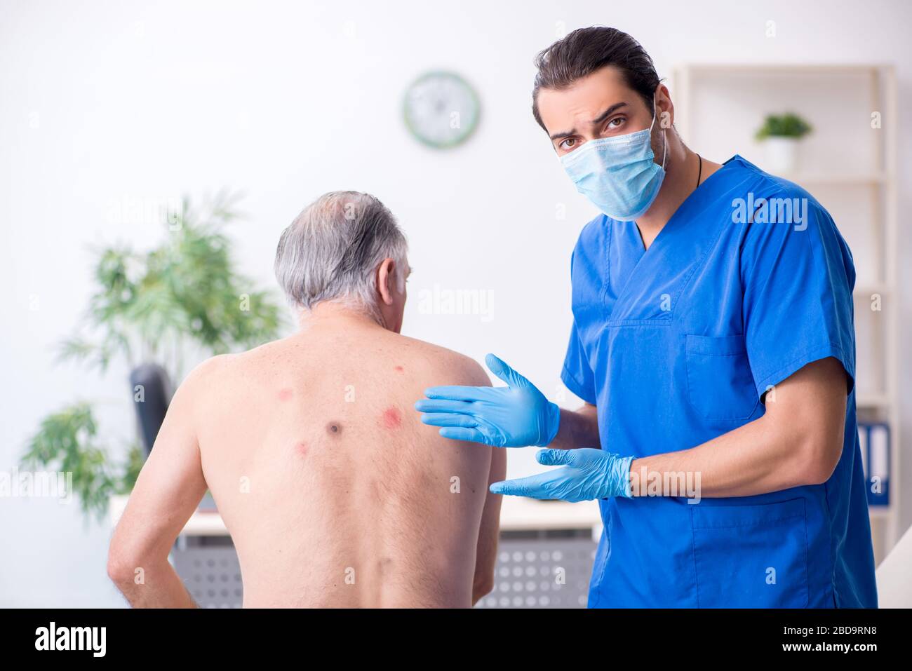 Old man visiting male doctor dermatologist Stock Photo - Alamy