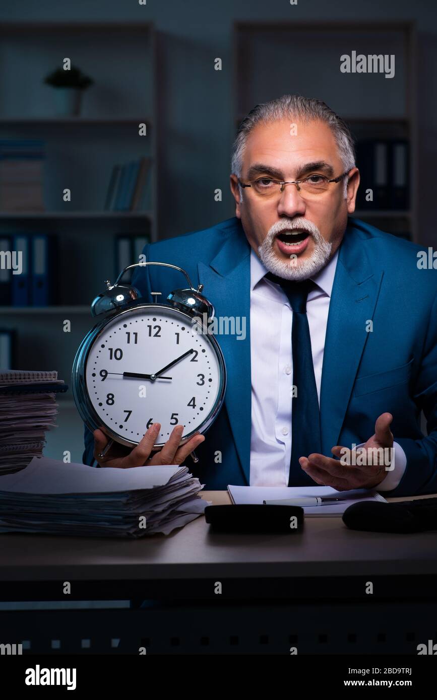 Old employee working late in the office Stock Photo - Alamy