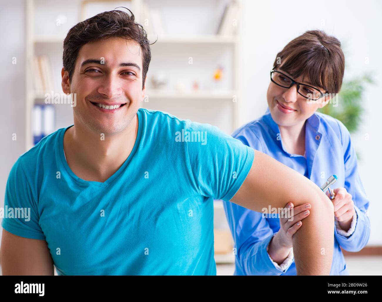 The doctor checking nerve reflexes with hammer Stock Photo - Alamy