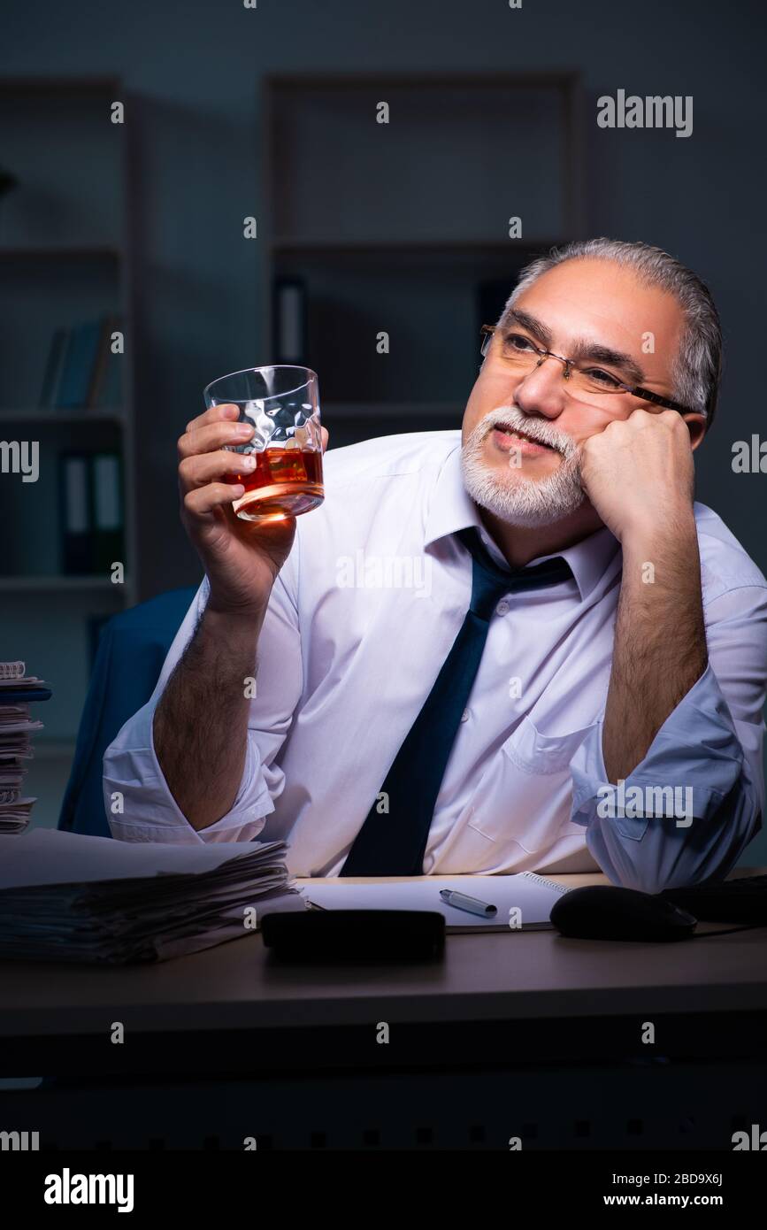 Old employee working late in the office Stock Photo - Alamy