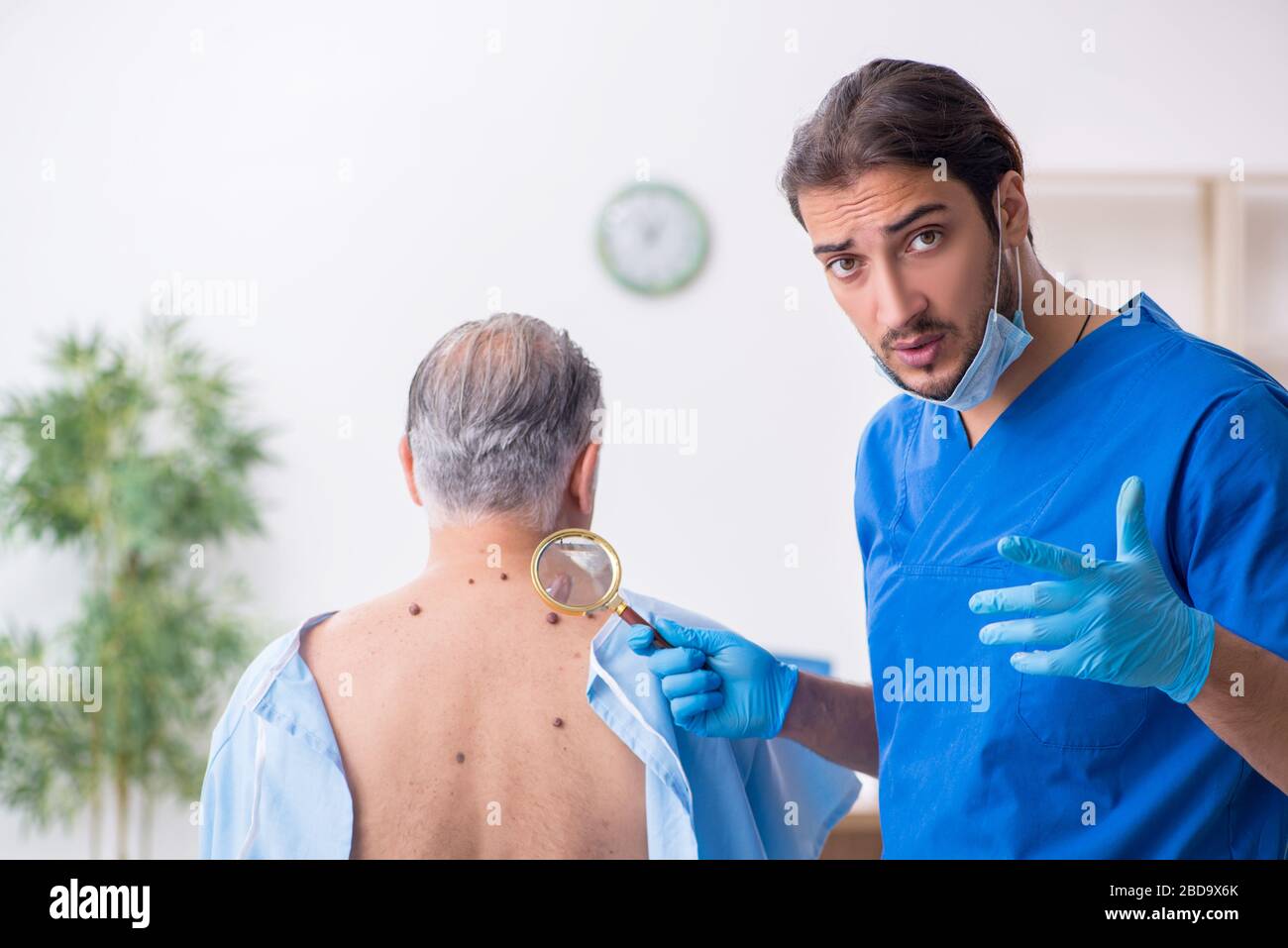Dermatologist examining mole magnifying glass hi-res stock photography ...