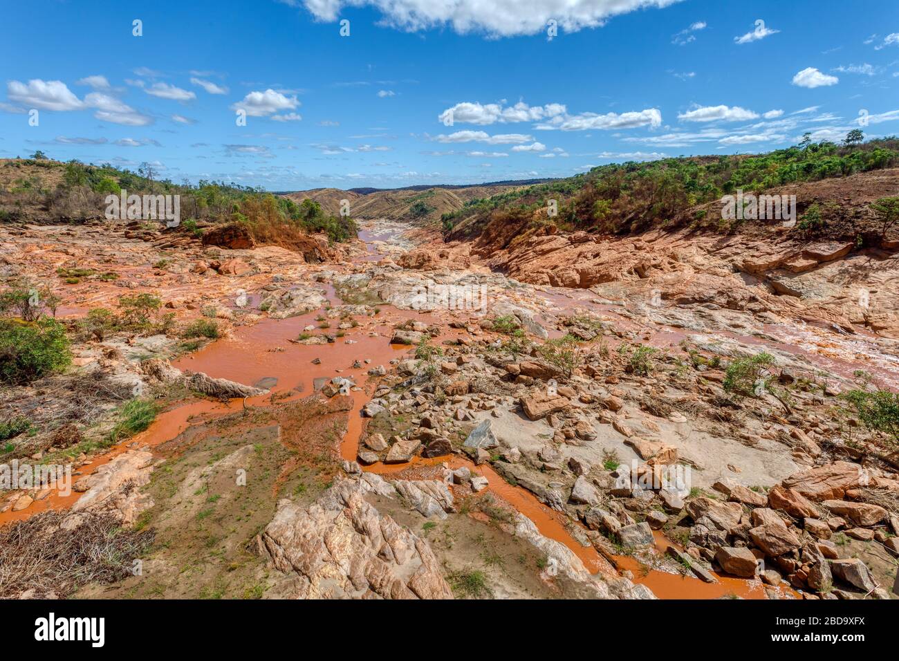 rocky river bed Betsiboka river after heavy rain, red yellow water ...