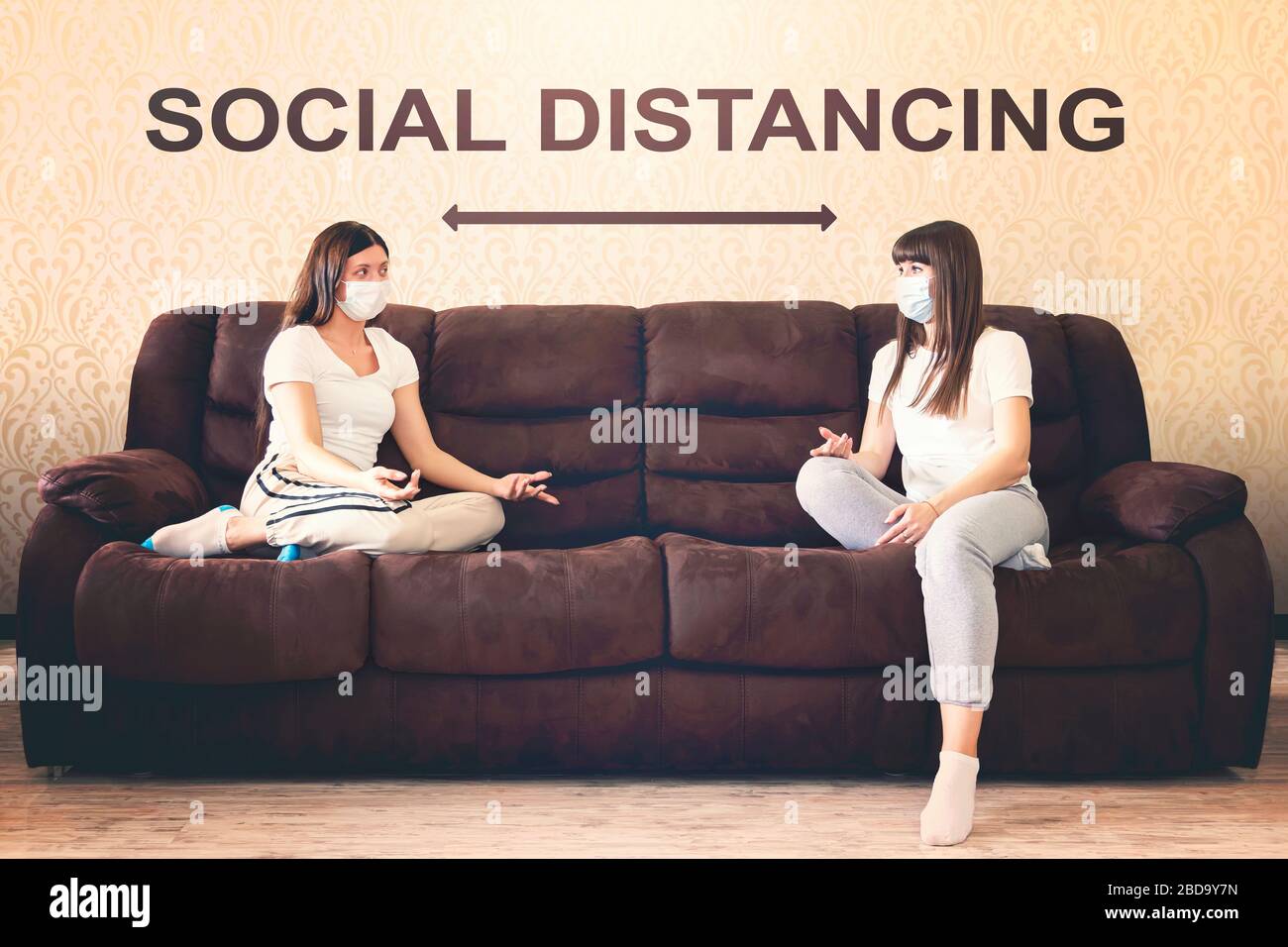 Two friends talk at a distance sitting on the sofa. the concept of ...
