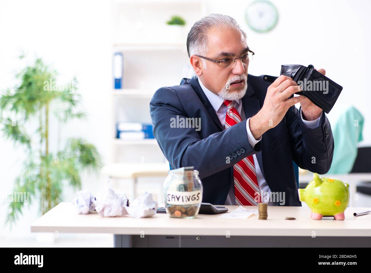 Old accountant in budget planning concept Stock Photo - Alamy