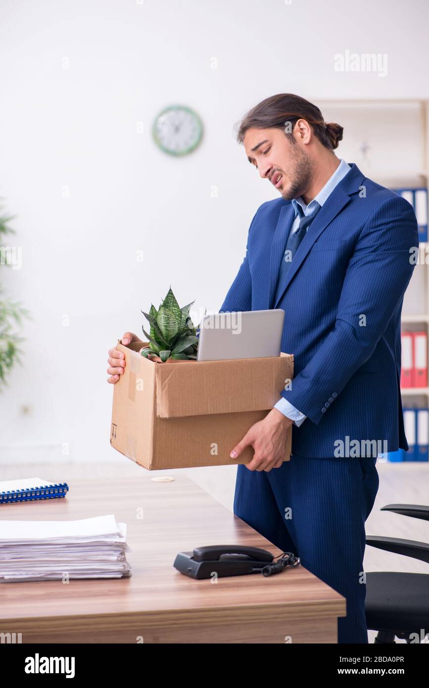 Young man being fired from his workplace Stock Photo - Alamy