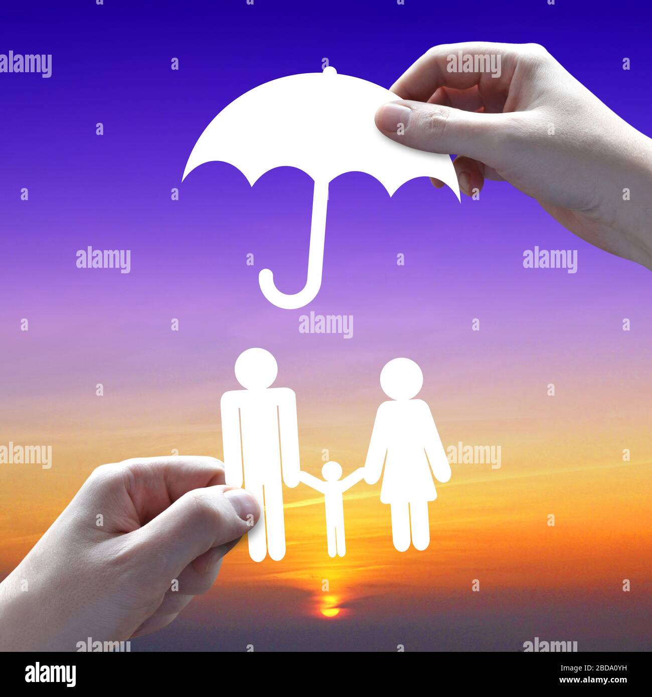 Family protection concept, hands, umbrella, sunset sky in background ...