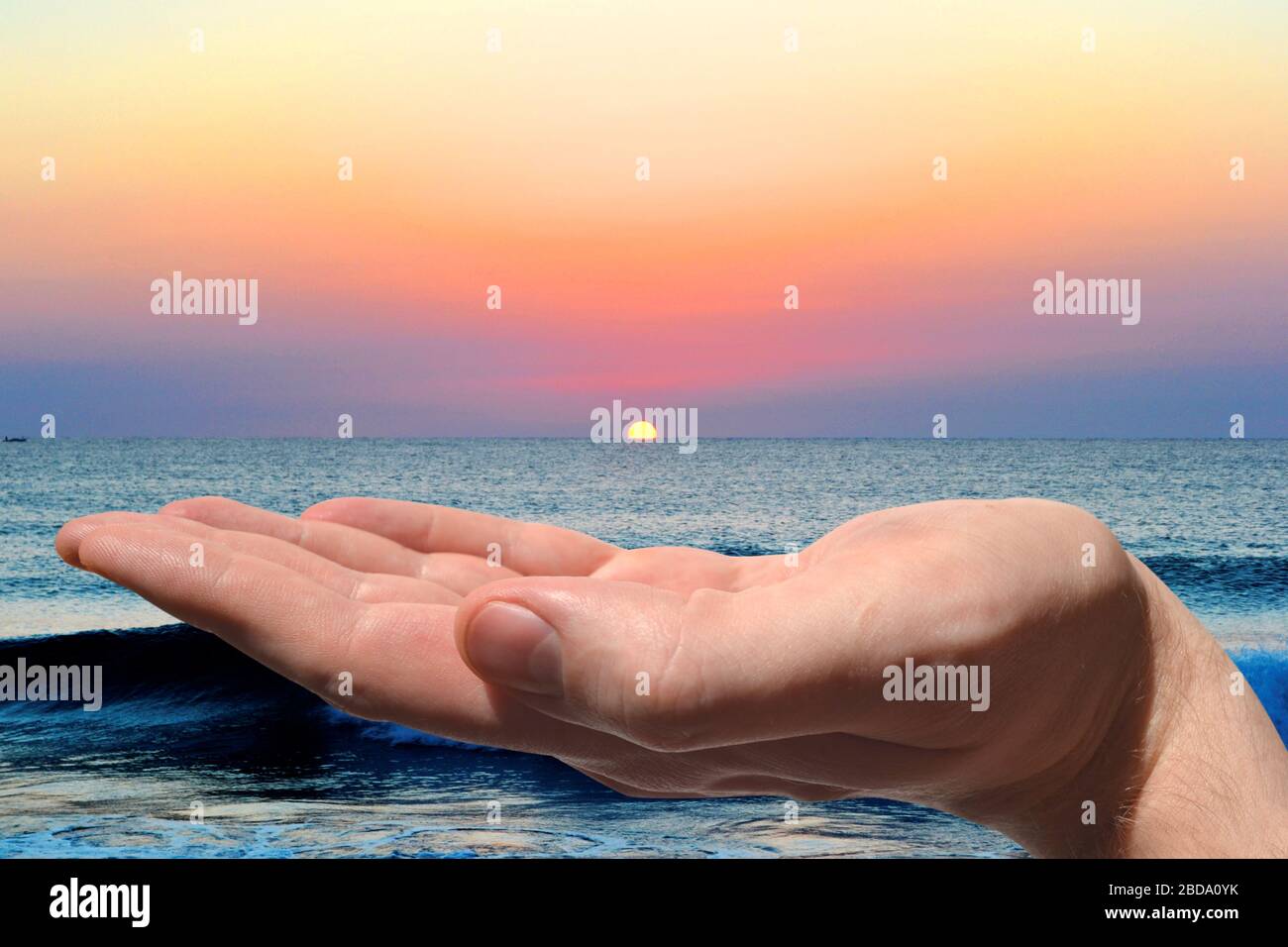 Hand and sunset sky, ocean Stock Photo - Alamy