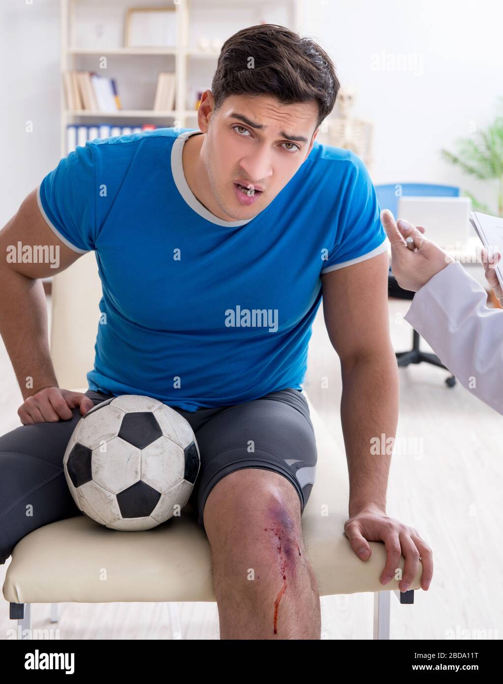 The football soccer player visiting doctor after injury Stock Photo - Alamy