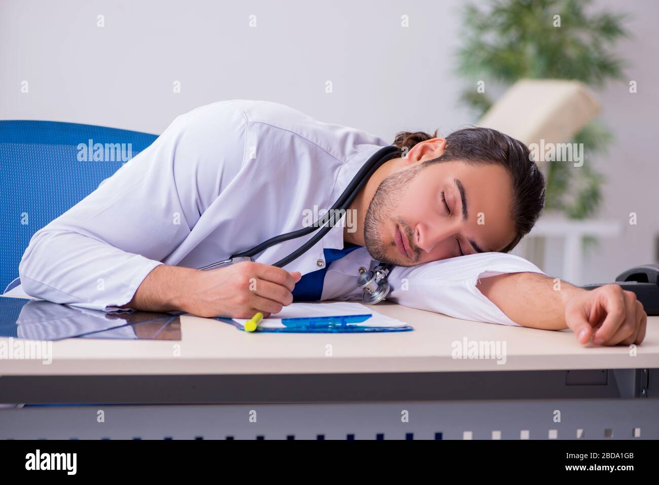 Young doctor being tired after night shift Stock Photo - Alamy
