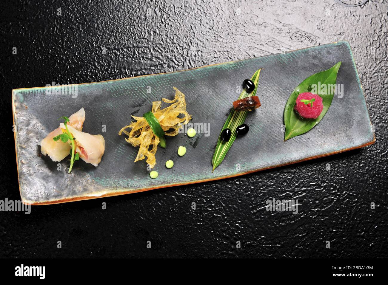 Various food served in the plate on the black table Stock Photo - Alamy