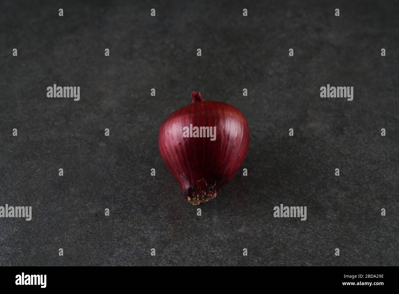 Red onion on dark background Stock Photo - Alamy