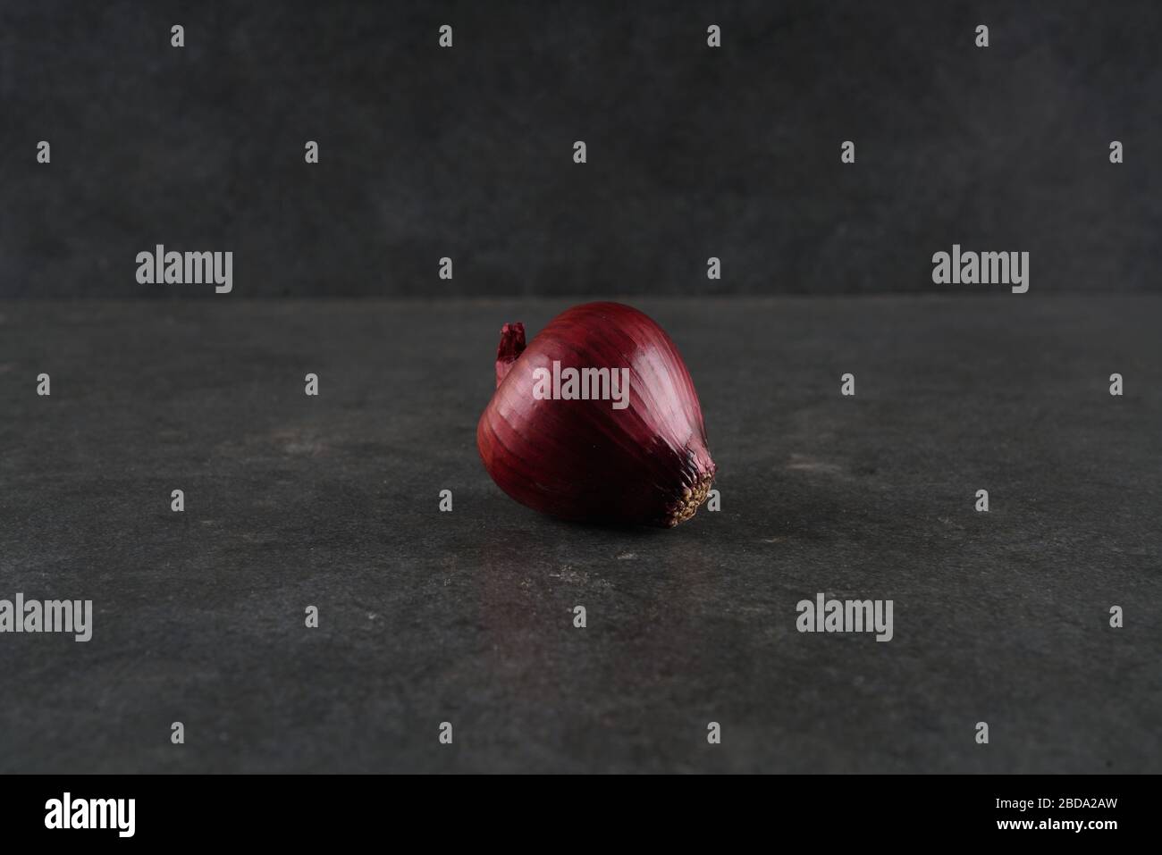 Red onion on dark background Stock Photo - Alamy