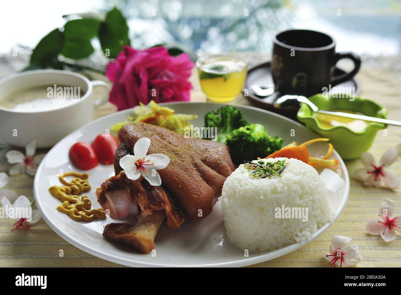 Pigs trotter over rice Stock Photo - Alamy