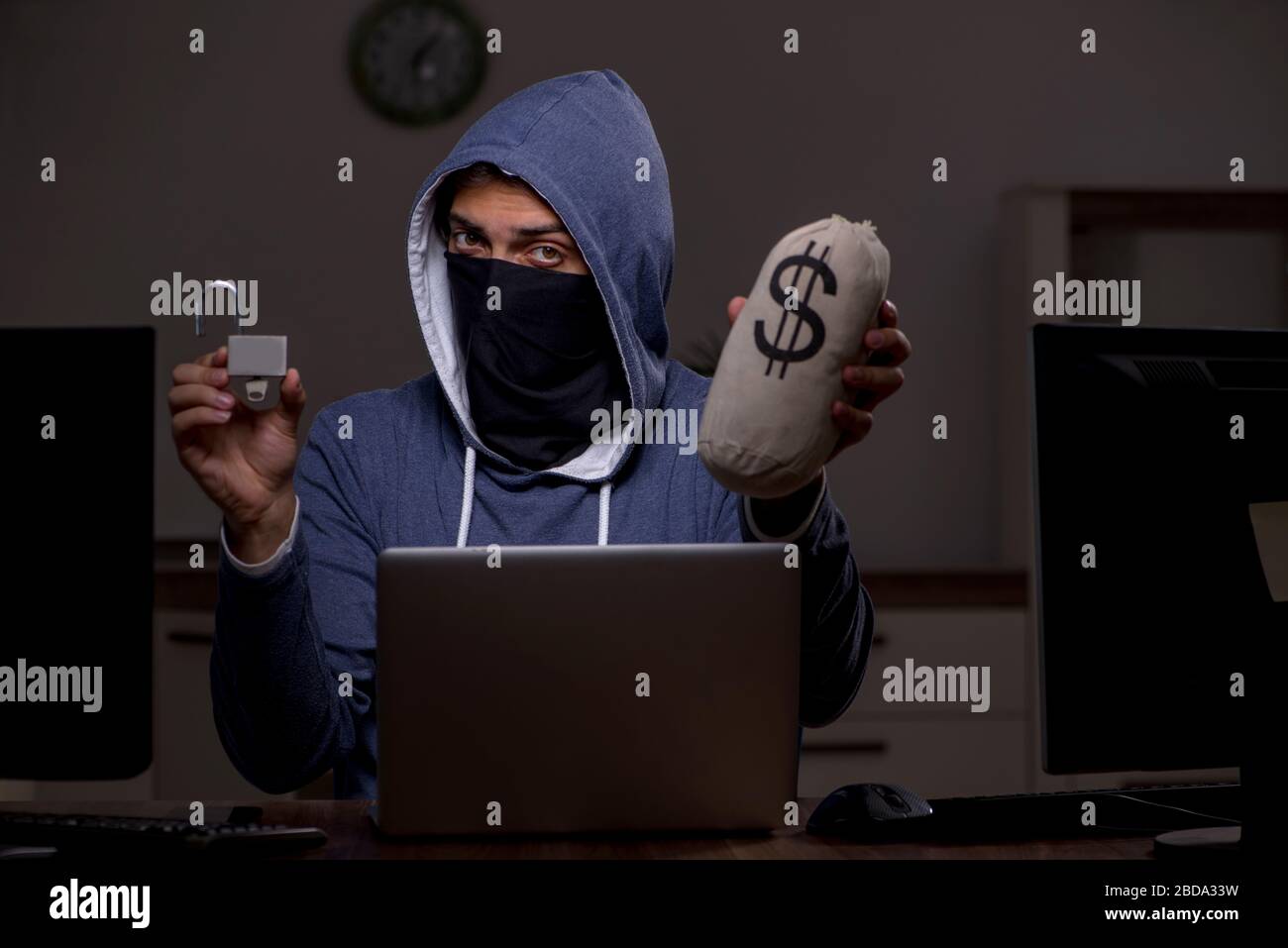 Male hacker hacking security firewall late in the office Stock Photo ...